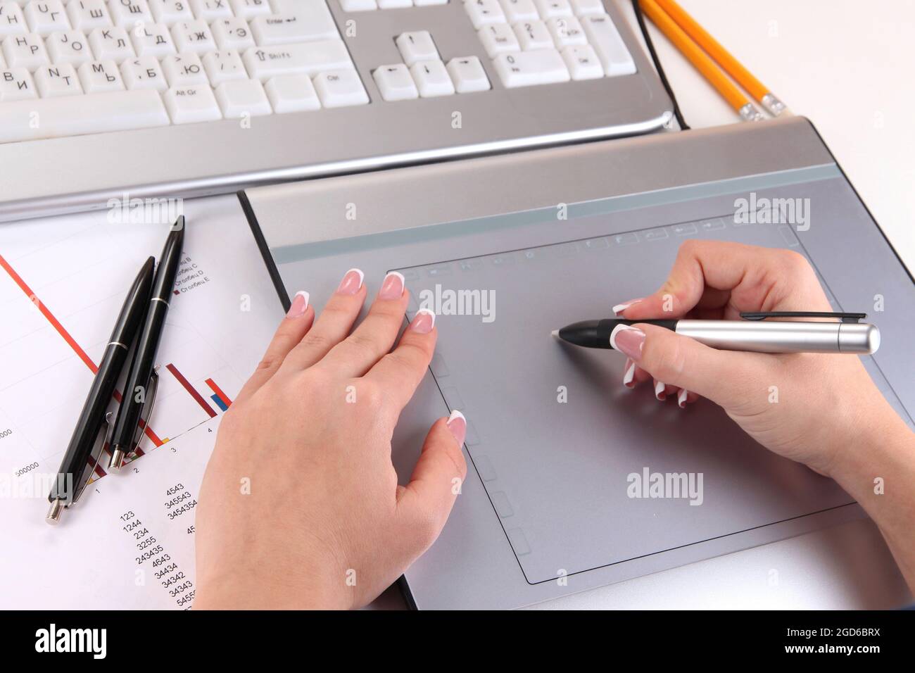 Female hand using graphics tablet on table close up Stock Photo - Alamy