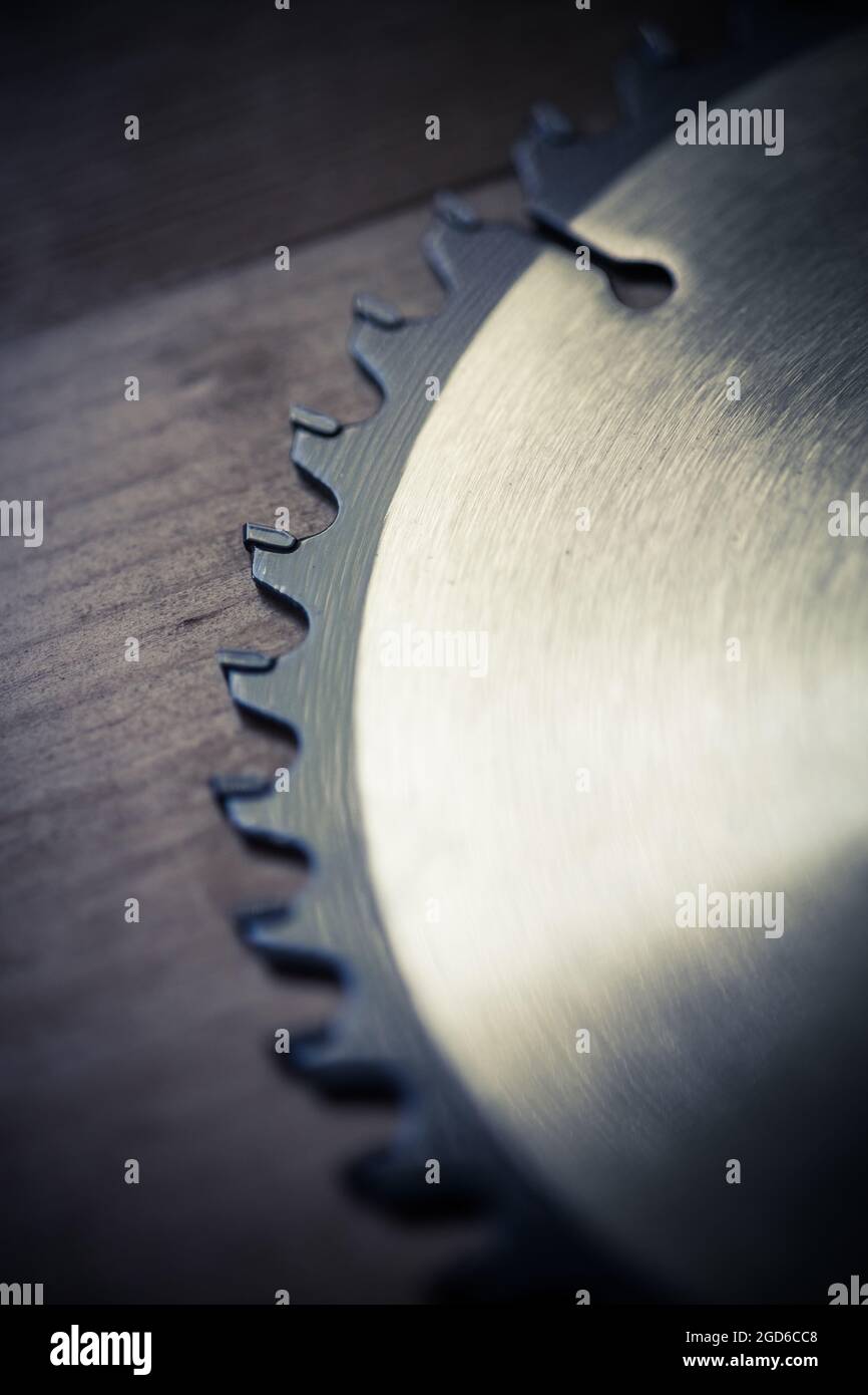 Color detail of a new circular saw blade on a wooden background Stock ...