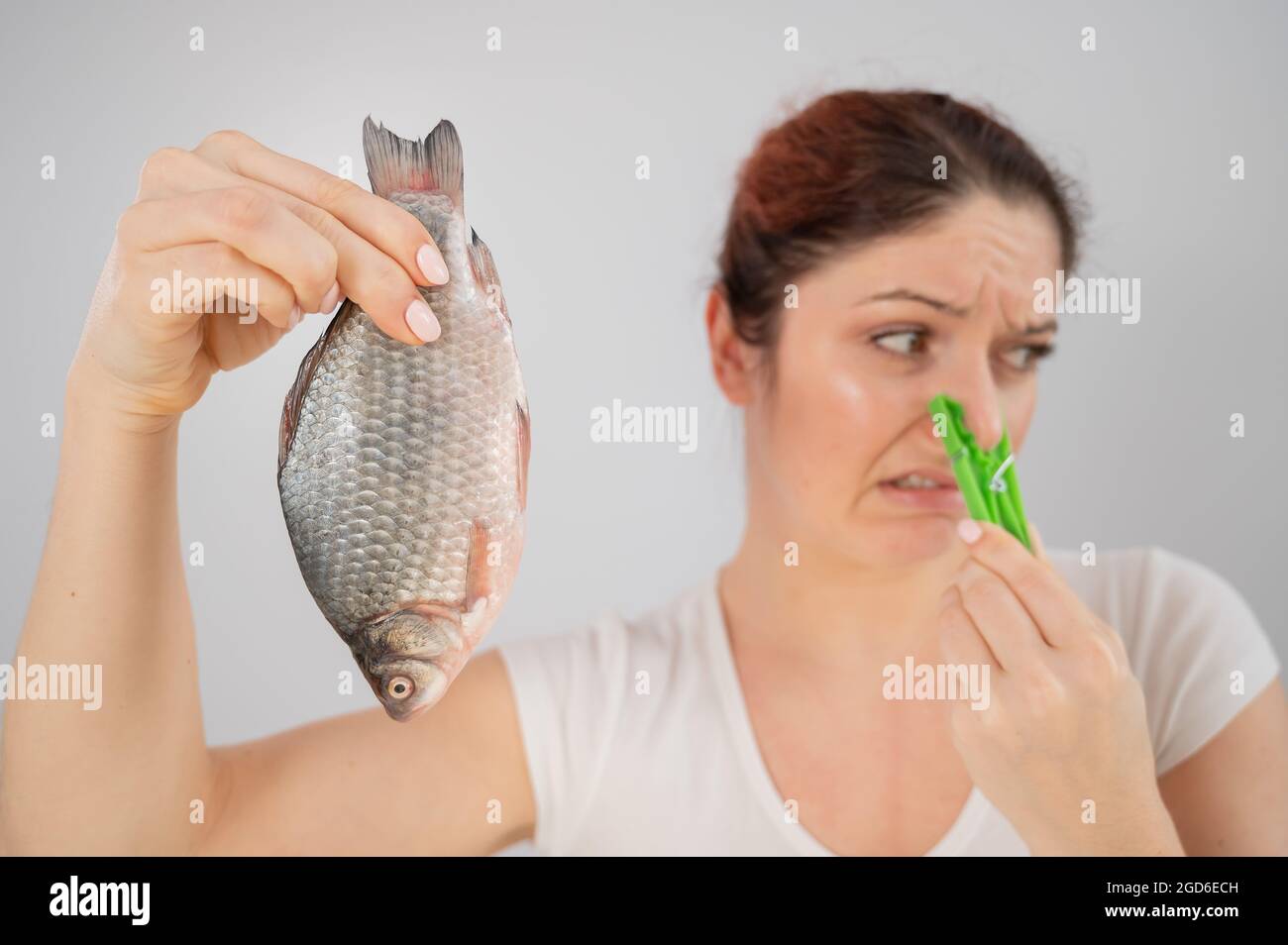 Caucasian woman with a clothespin on her nose because of the disgusting ...