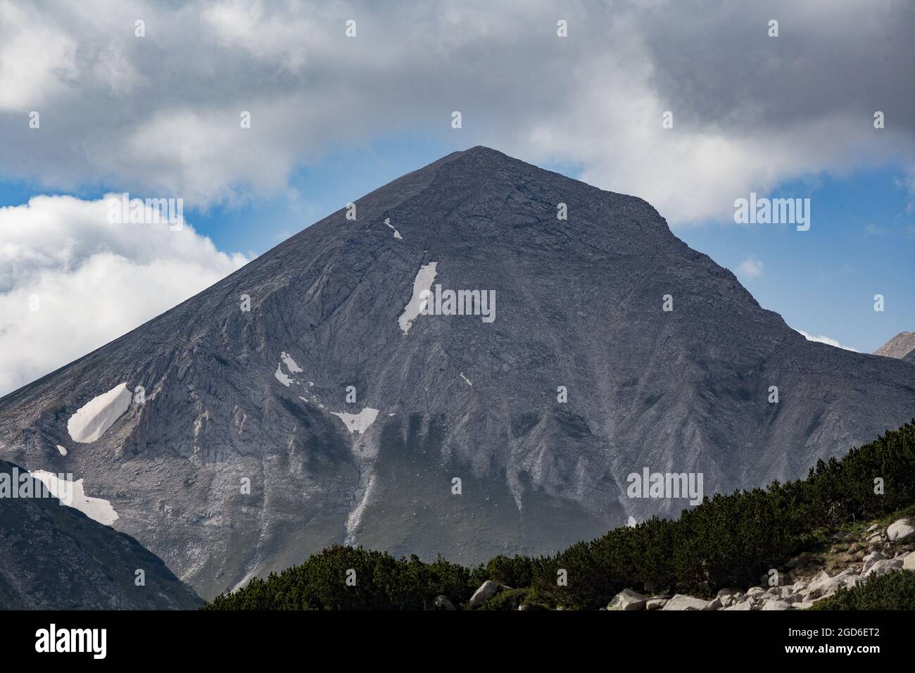 Low angle shot of the magnificent mountain peak under the cloudy sky ...
