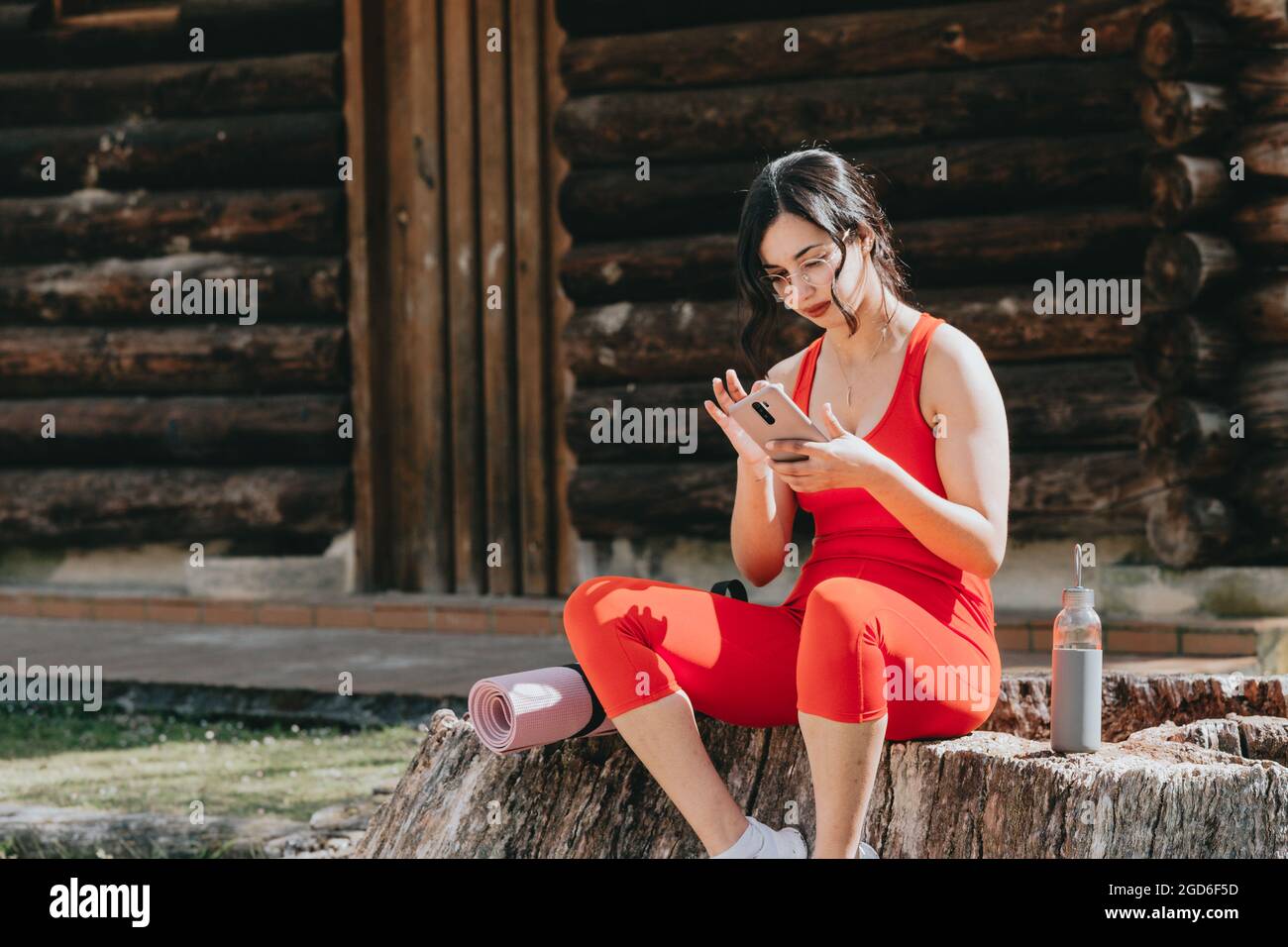 Middle Eastern female wearing yoga clothes resting after practicing in ...