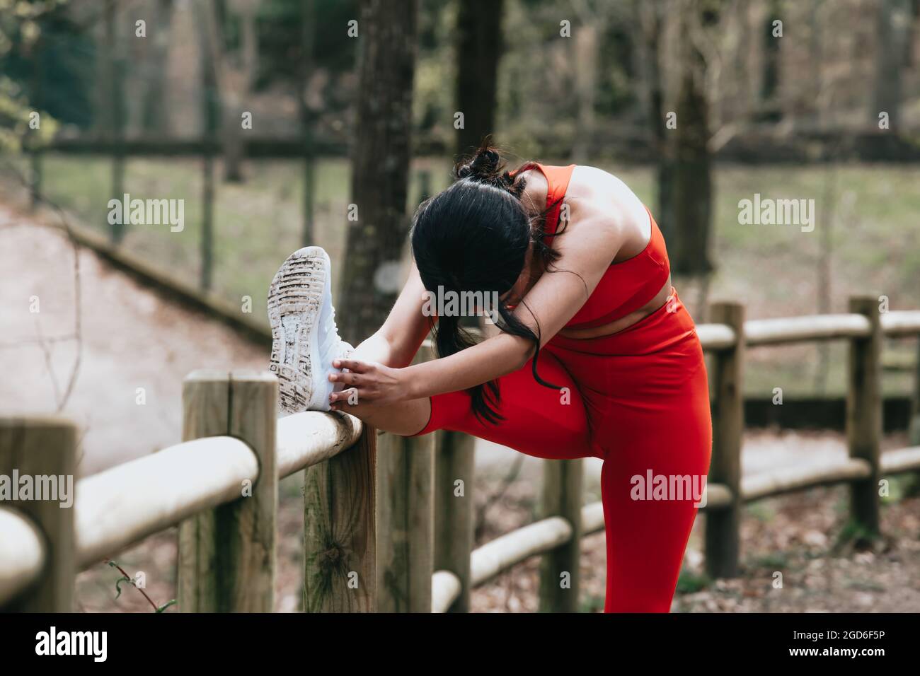 Middle Eastern female practicing a difficult yoga pose in the park ...