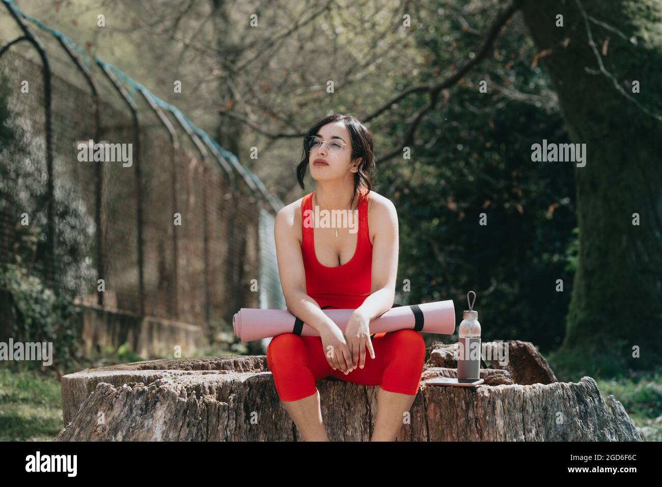 Middle Eastern female in yoga clothes resting after exercising in the ...