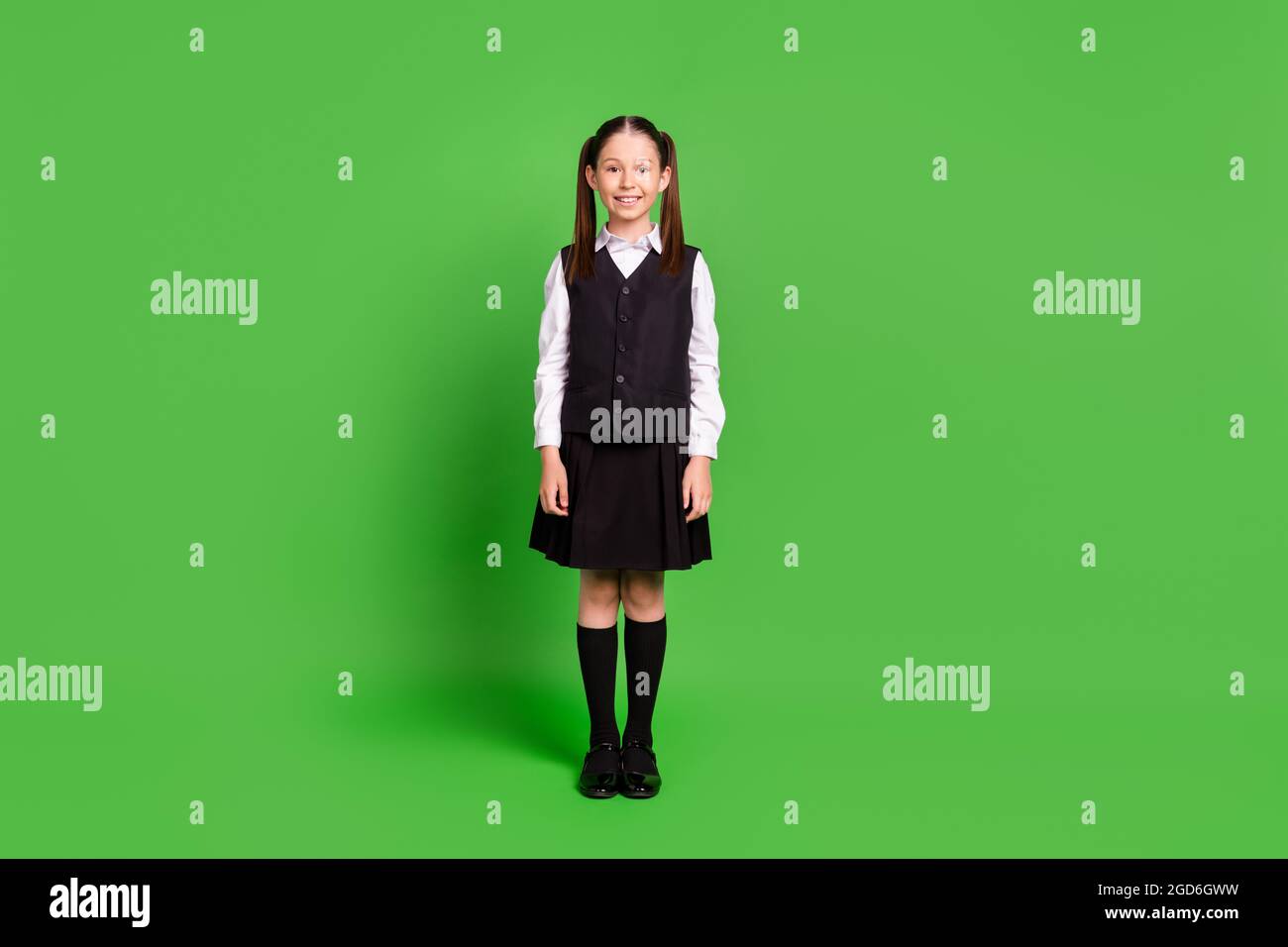 Photo of adorable shiny school girl wear black white uniform standing ...