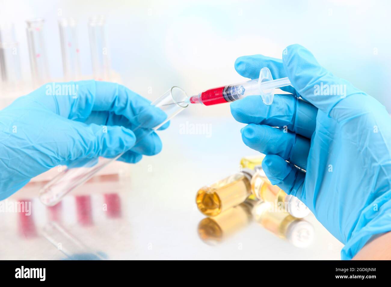 Technician injecting blood sample in test tube analysis, on light ...