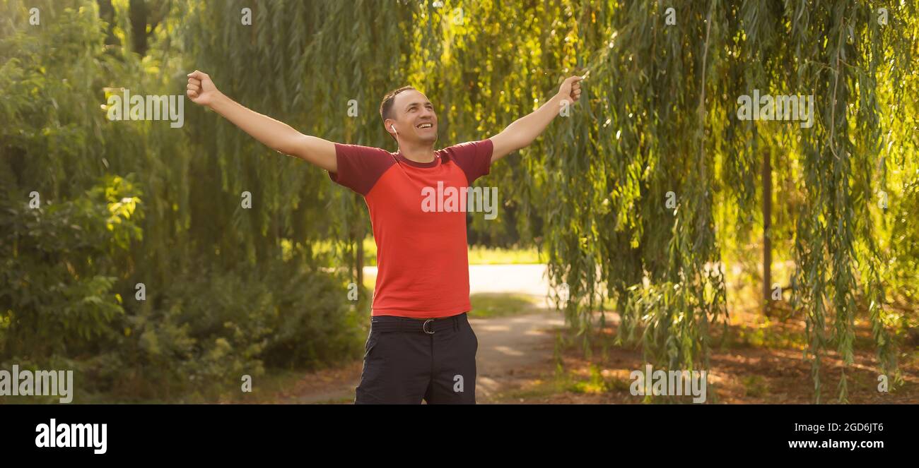 Successful man jogger raising arms hi-res stock photography and images ...
