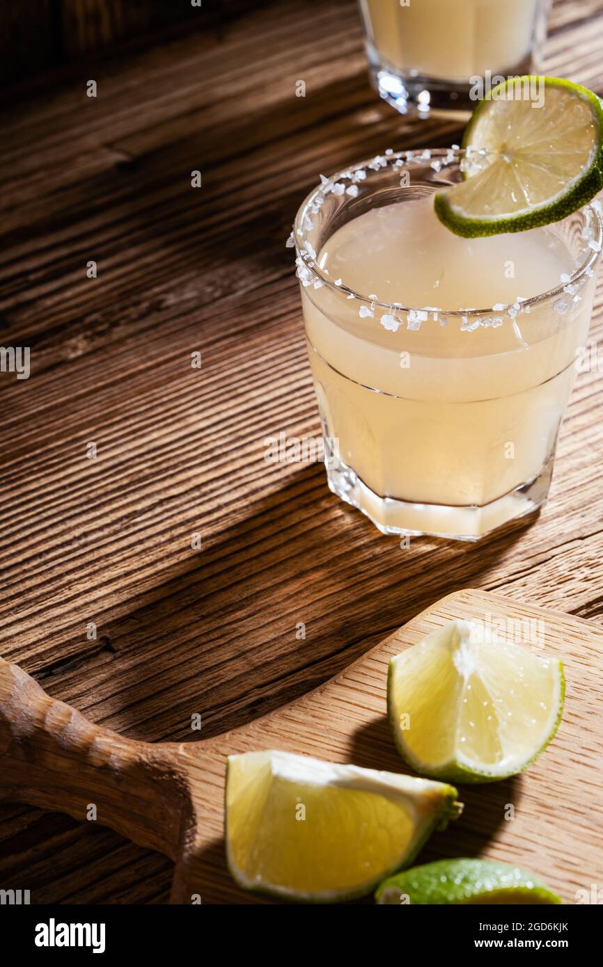 Margarita cocktail with salt rim on rustic wood table Stock Photo - Alamy