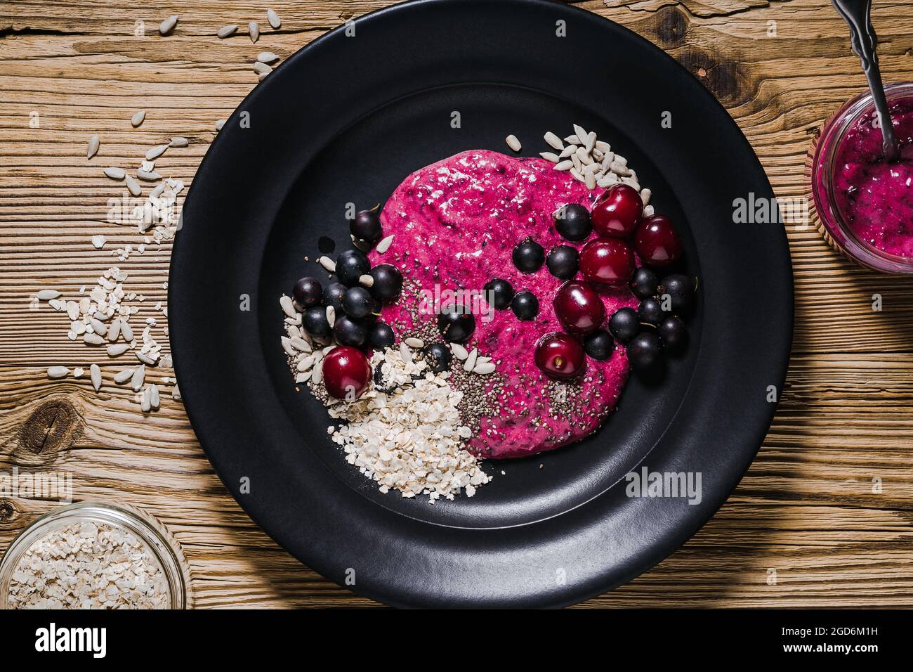 Berry breakfast smoothie bowl. Fresh ripe black currants, cherries ...