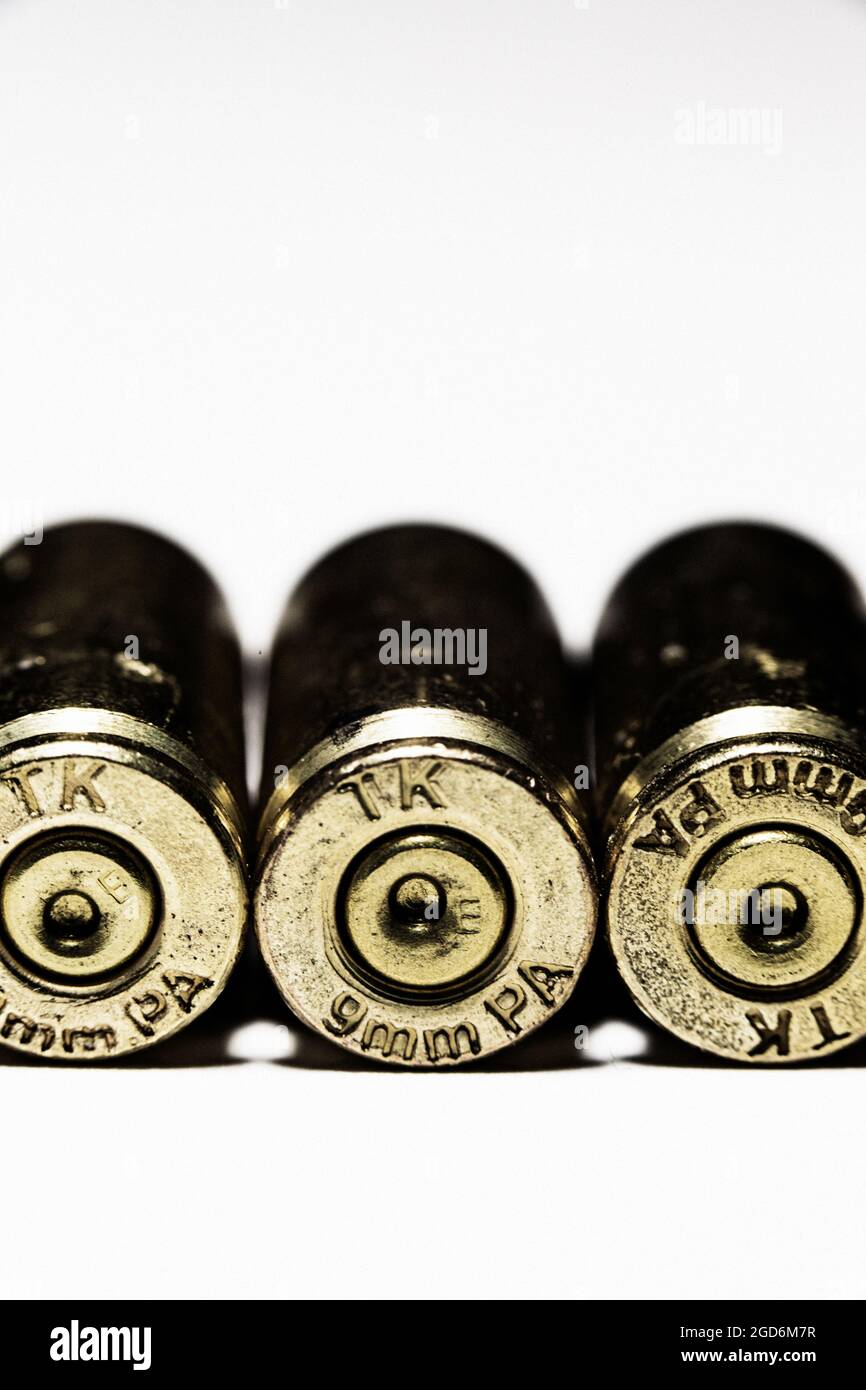 Three used cartridges cases on white background Stock Photo - Alamy