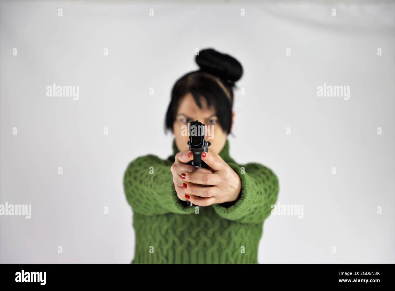 Women with a gun pointing Stock Photo - Alamy