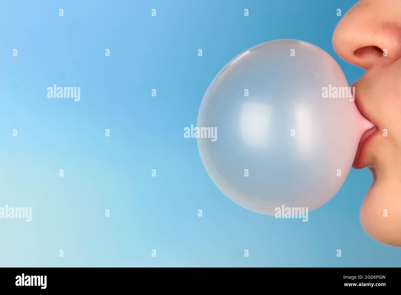 Person doing bubble with chewing gum on bright background Stock Photo ...