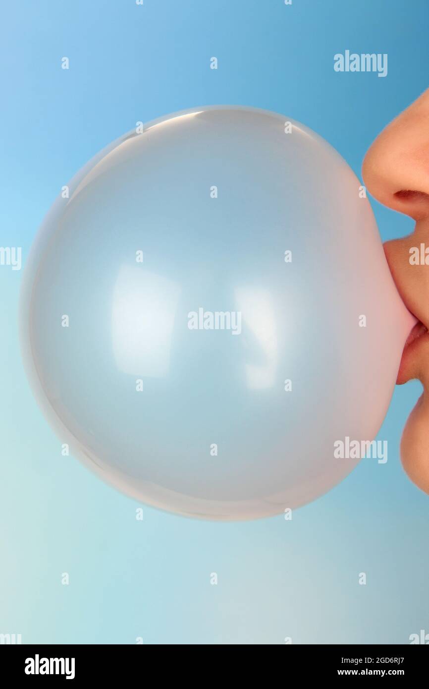 Person doing bubble with chewing gum on bright background Stock Photo ...