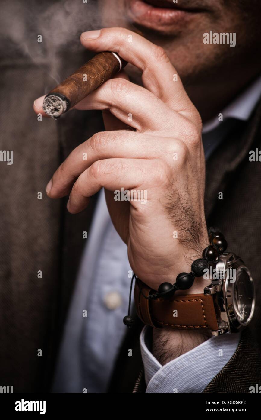 elegant man wearing suit and white shirt smoking cigar indoor Stock ...