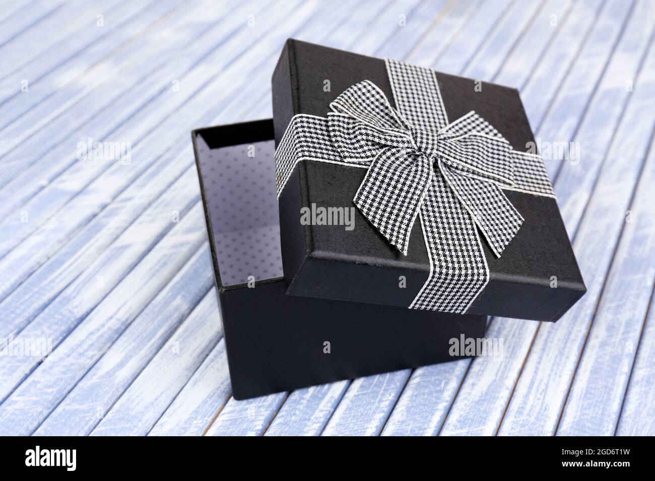 Open gift box on wooden background Stock Photo - Alamy