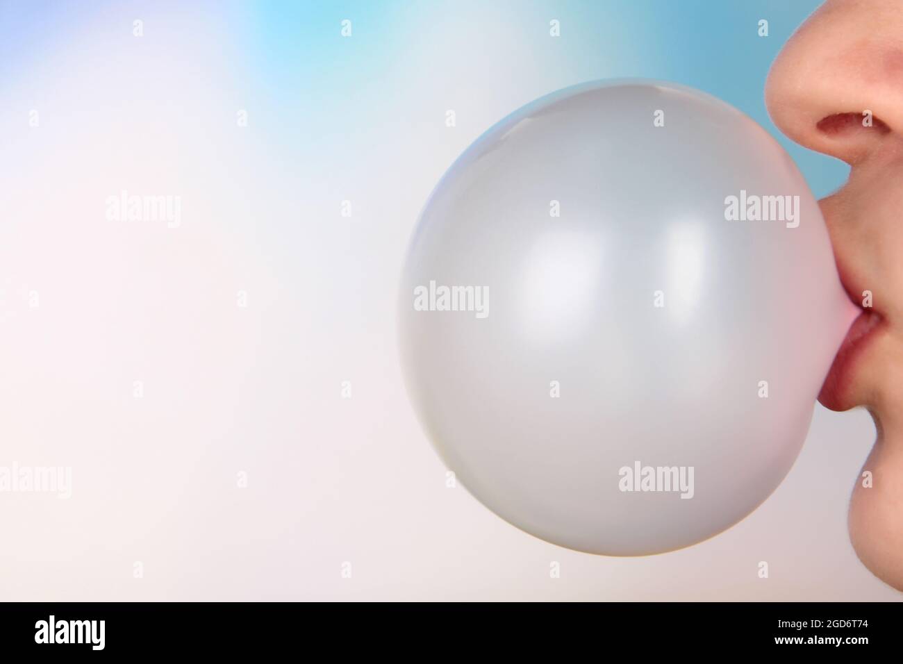 Person doing bubble with chewing gum on bright background Stock Photo ...