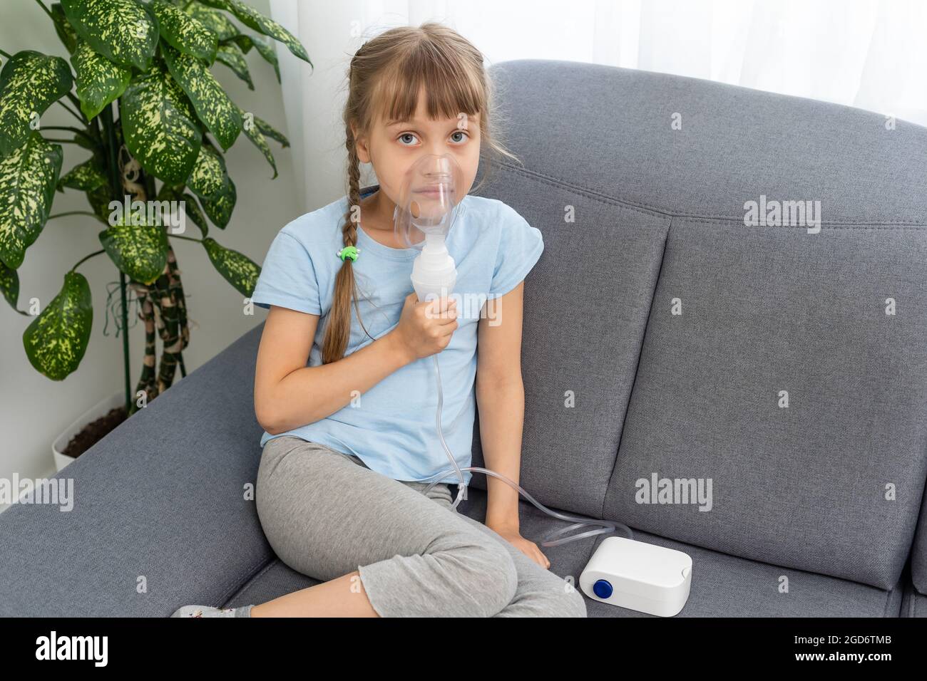 Little girl making inhalation with nebulizer at home. child asthma ...