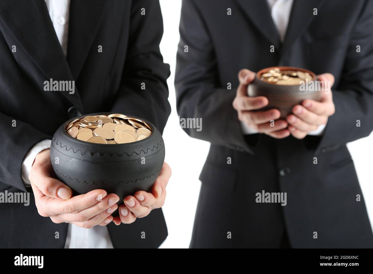 Two ceramic pots with golden coins in male and female hands, isolated ...