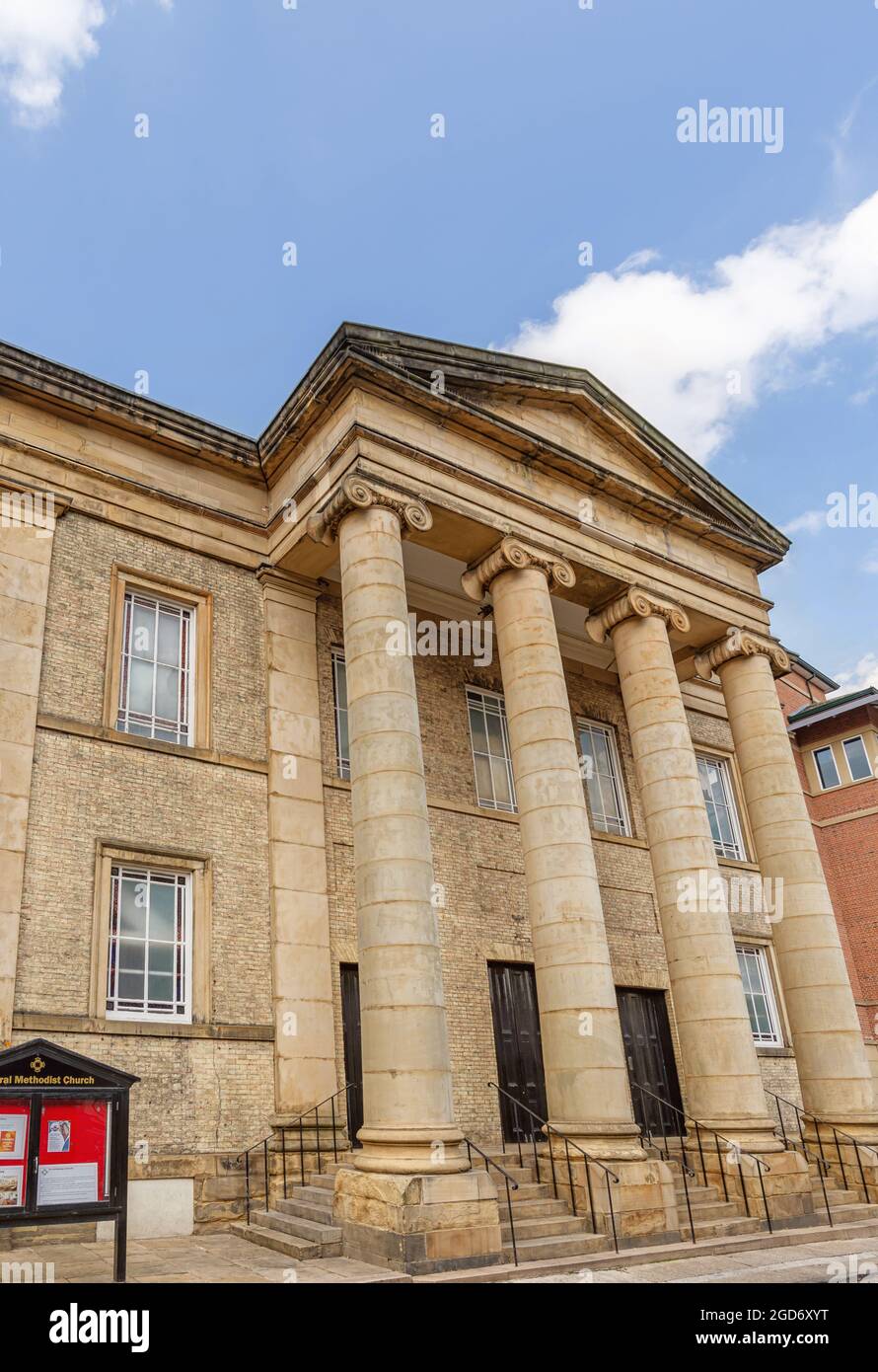 Tall columns at the entrance to a Methodist Church. Steps lead up to ...