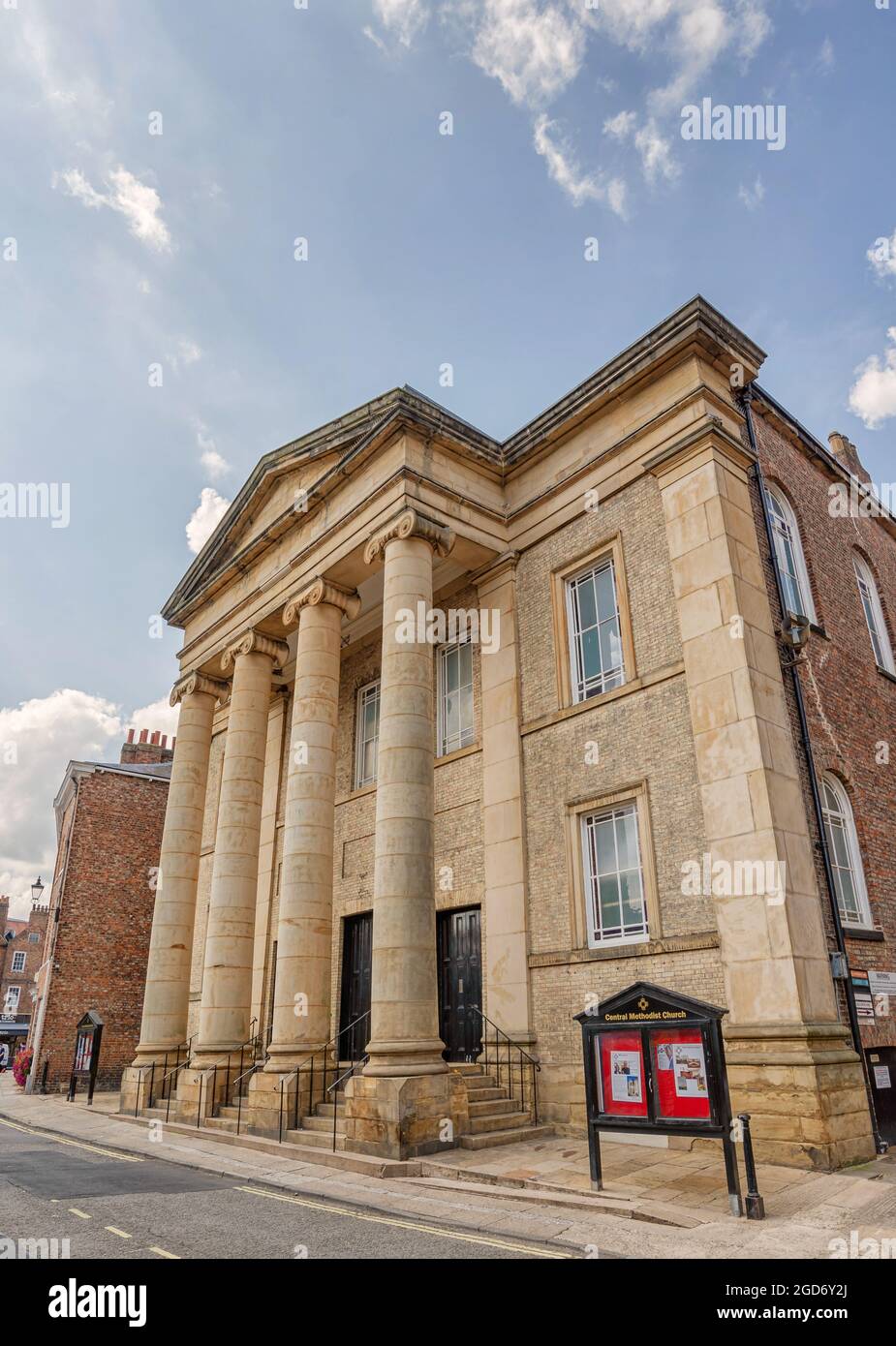 Tall columns at the entrance to a Methodist Church. Steps lead up to ...