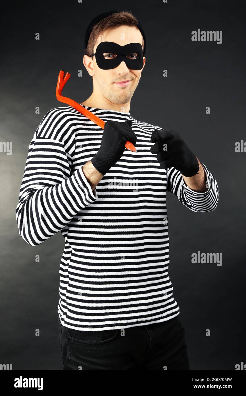 Thief on dark background Stock Photo - Alamy