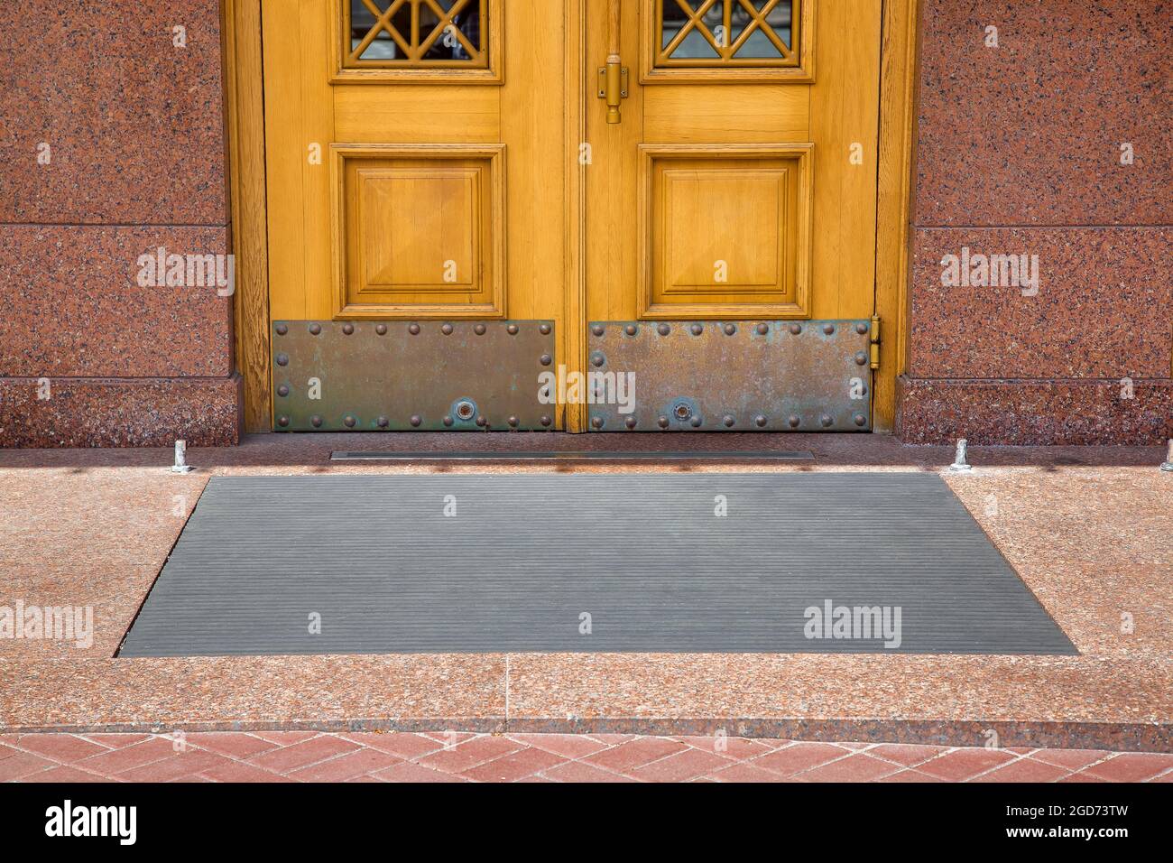 stone threshold with foot mat at the entrance door made of wood and ...