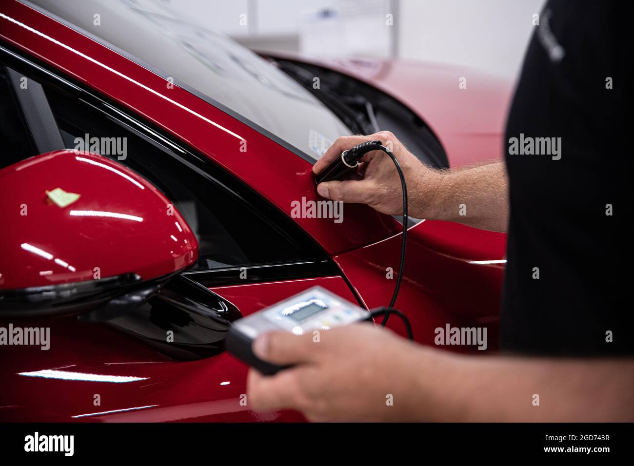 Man mechanic checking car paint thickness with electronic meter Stock ...