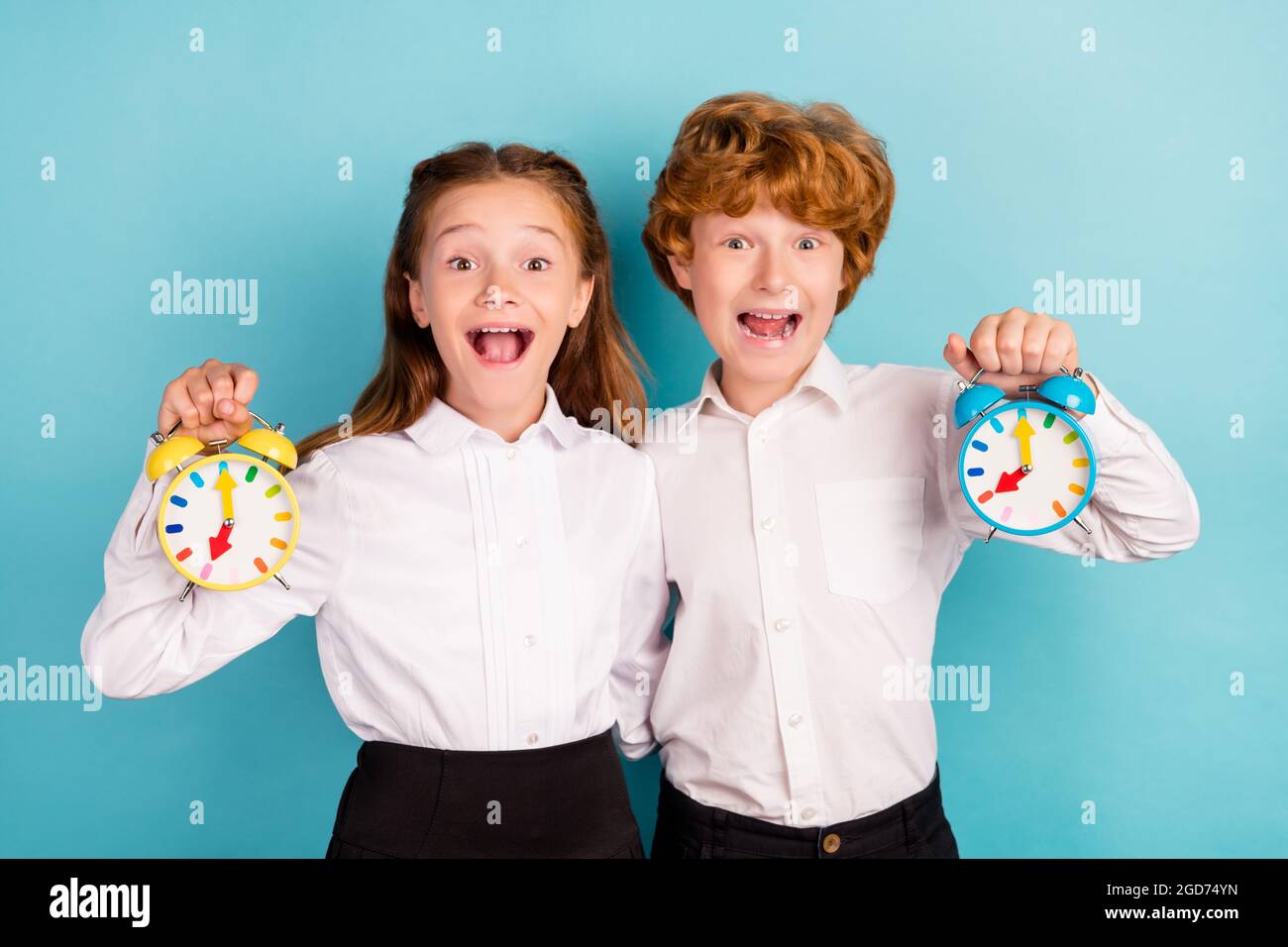 Portrait of two attractive amazed cheerful friends holding childish ...