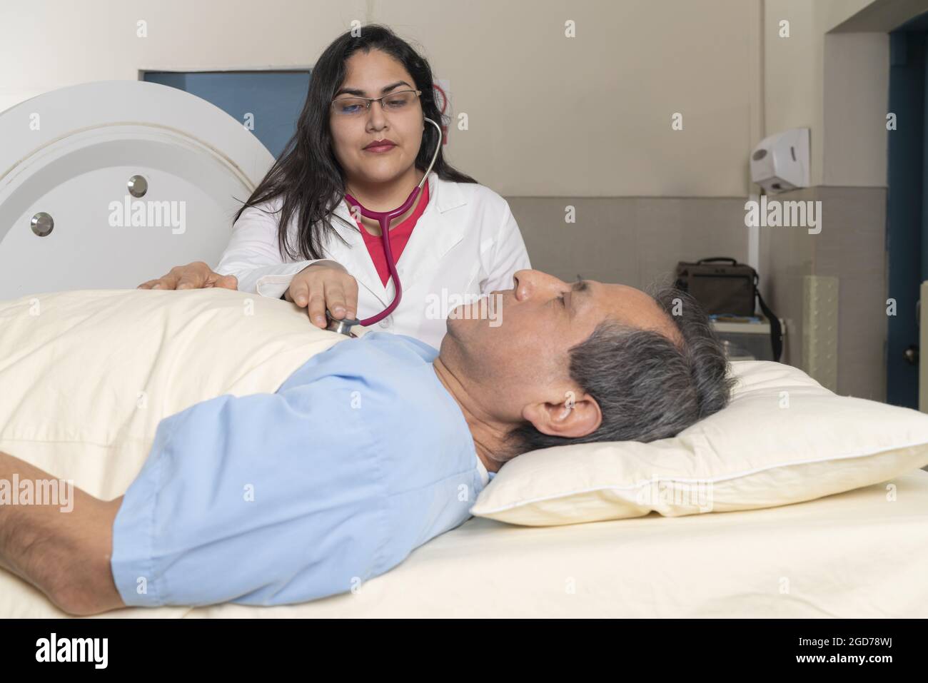 Doctor auscultating a patient with a stethoscope Stock Photo - Alamy