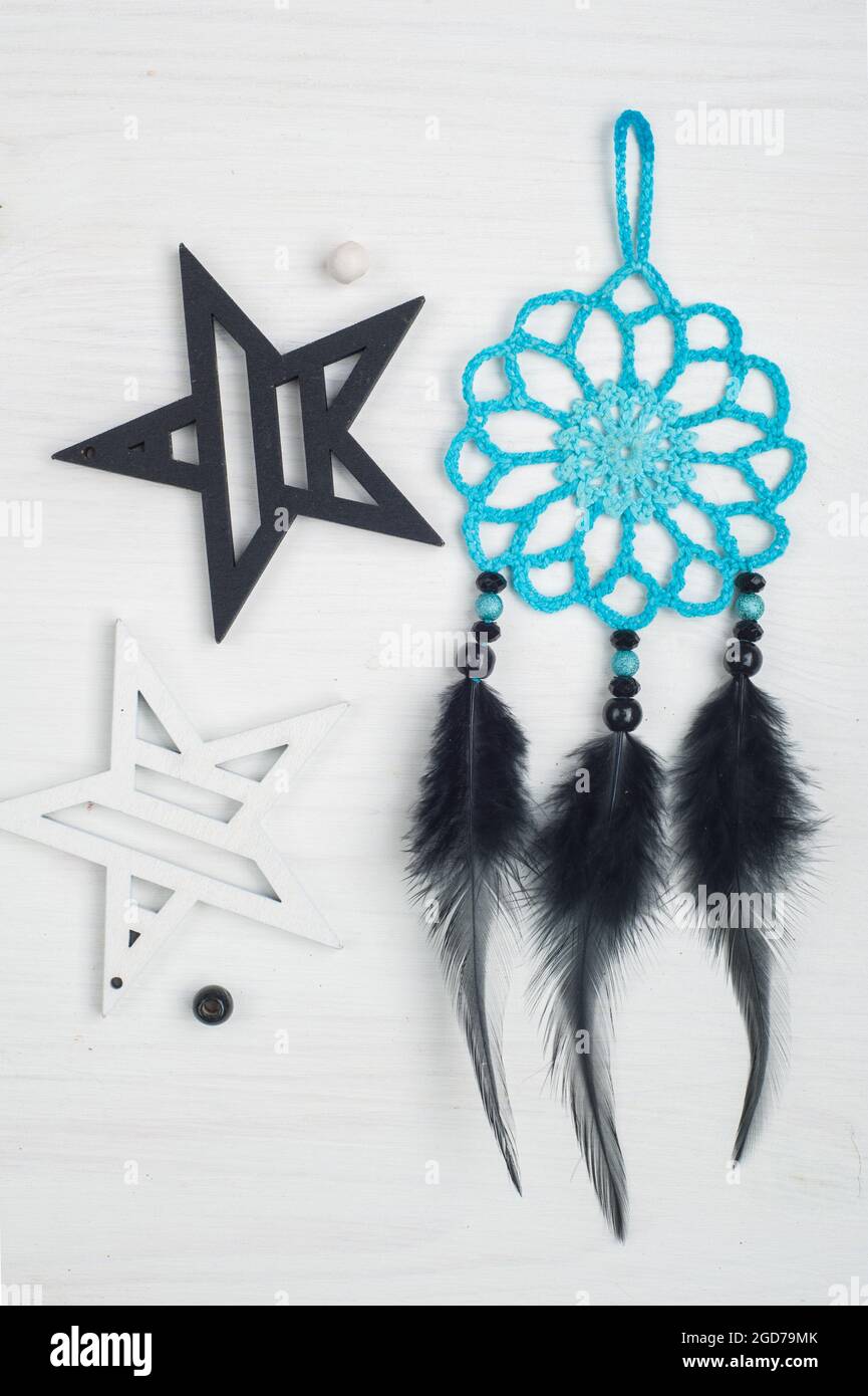 Christmas wooden decoration and turquoise dream catcher on table ...