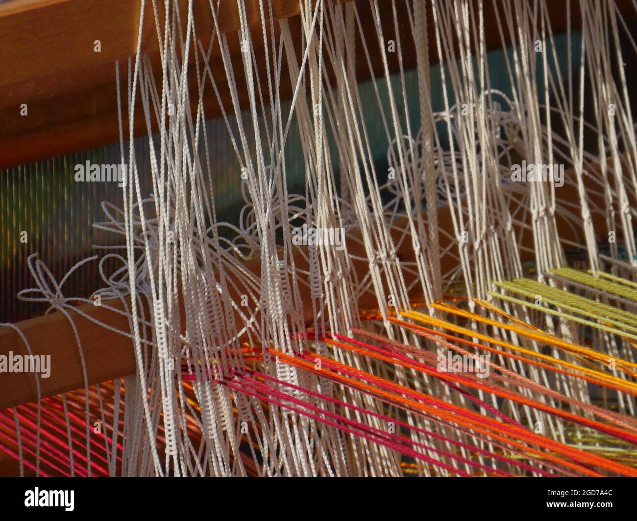 Detail of the threads of a hand loom, the back threads in the blurred ...