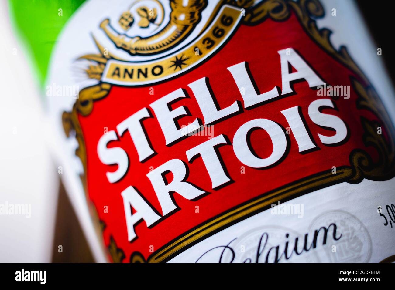 A man holds a Stella Artois beer bottle. It is a premium pilsner beer ...