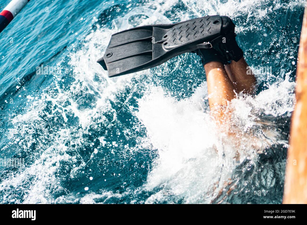 Closeup of a diver's flippers on the surface of the sea and the ...
