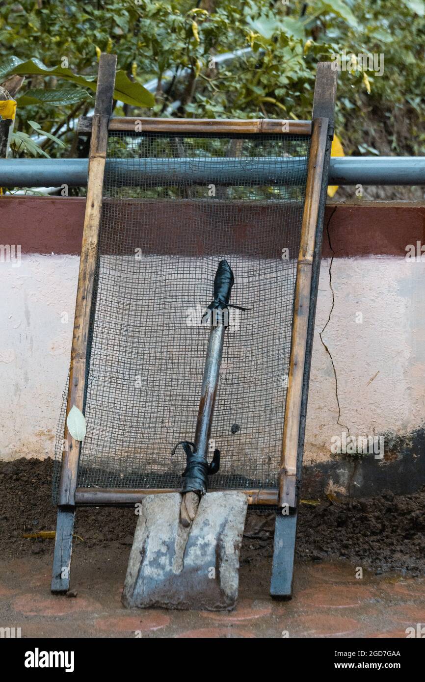 Shovel and sieve after use for gardening and it's rain Stock Photo - Alamy