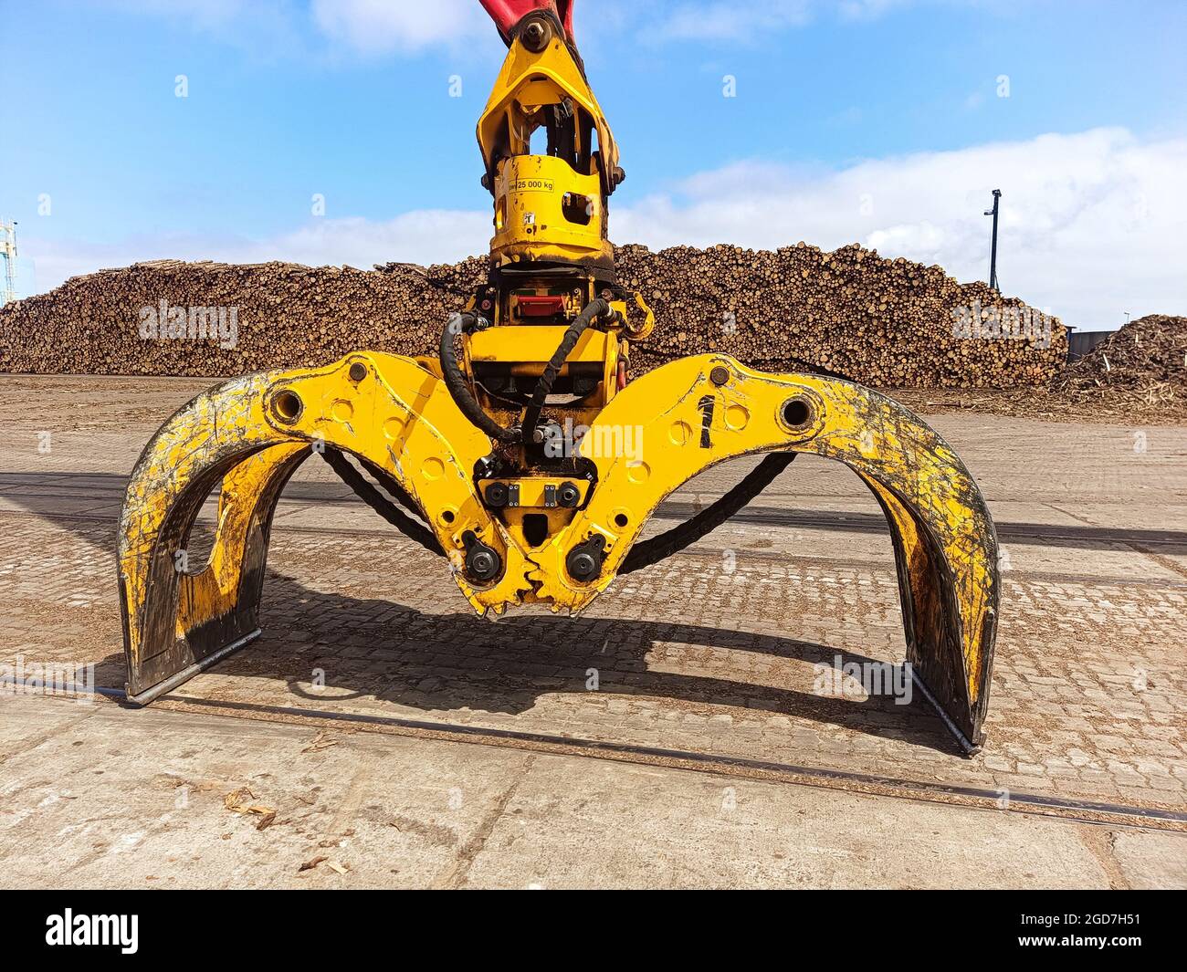 A grab bucket at the berth for loading timber onto ships in the port at ...