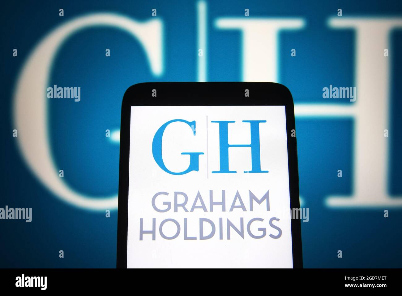In this photo illustration a Graham Holdings Company logo is seen on a ...