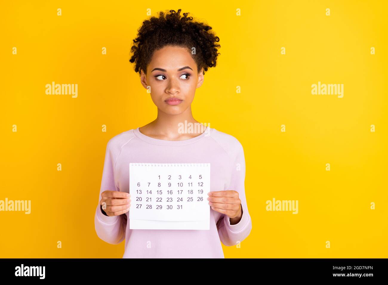 Photo of young serious calm dark skin woman look empty space hold ...