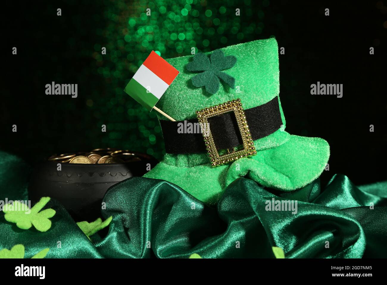 Saint Patrick day hat, pot of gold coins and Irish flag on green shiny ...