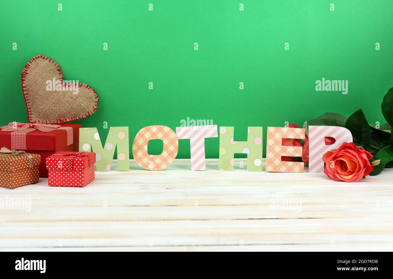 Mother- lettering of handmade paper letters on green background Stock ...