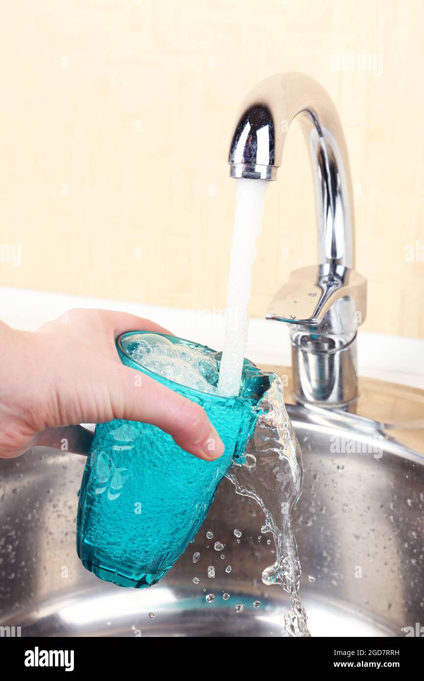 Filling up glass of water Stock Photo - Alamy