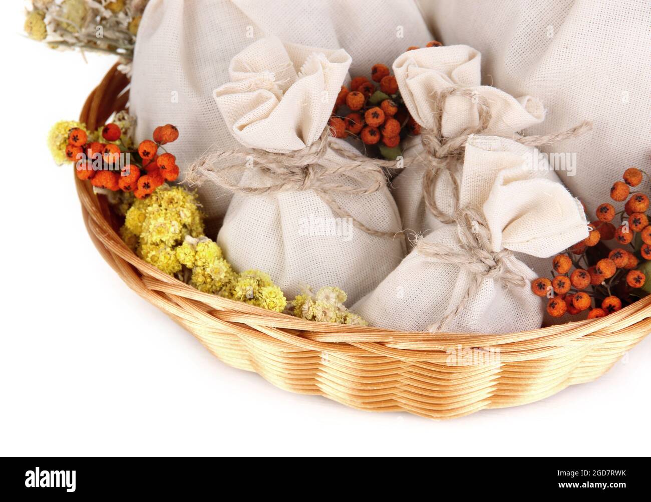 Textile sachet pouches with dried flowers, herbs and berries in wicker ...