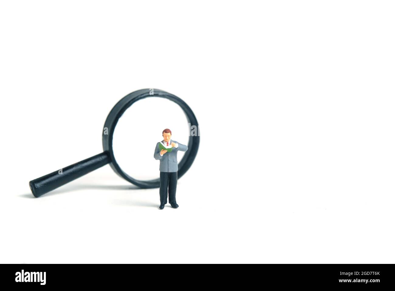 Miniature people toy figure photography. A men student standing in ...