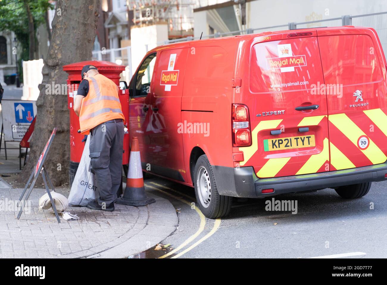 Postman collecting posts from letter box hi-res stock photography and ...