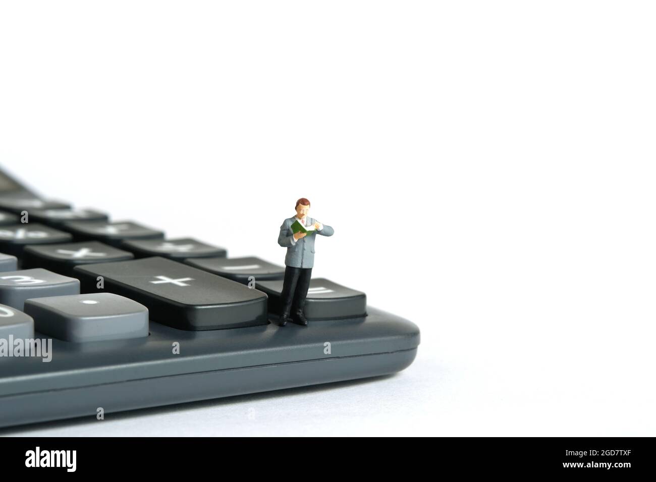 Miniature people toy figure photography. A men student standing above ...