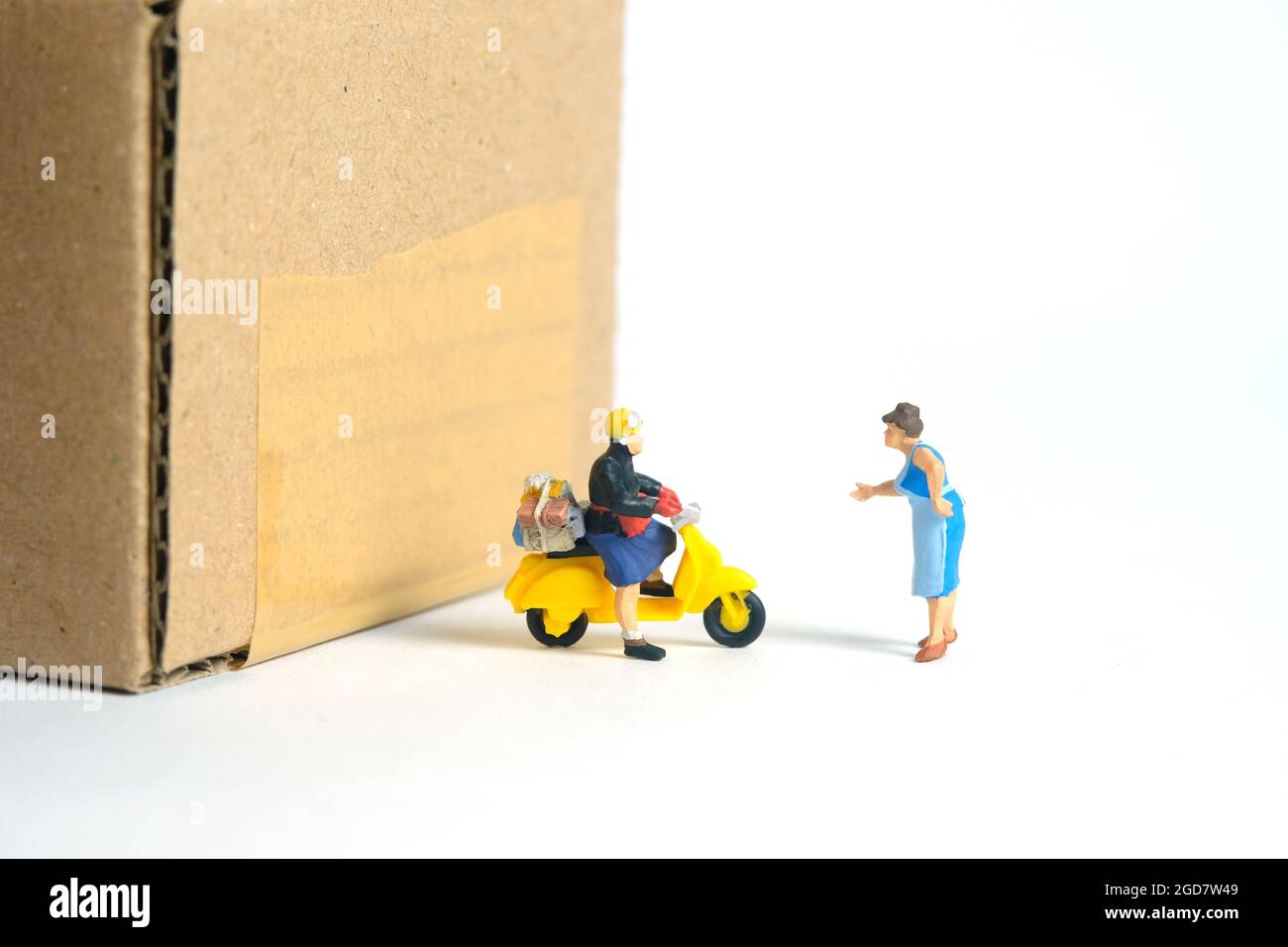 Miniature people toys conceptual photography. Post parcel package ...
