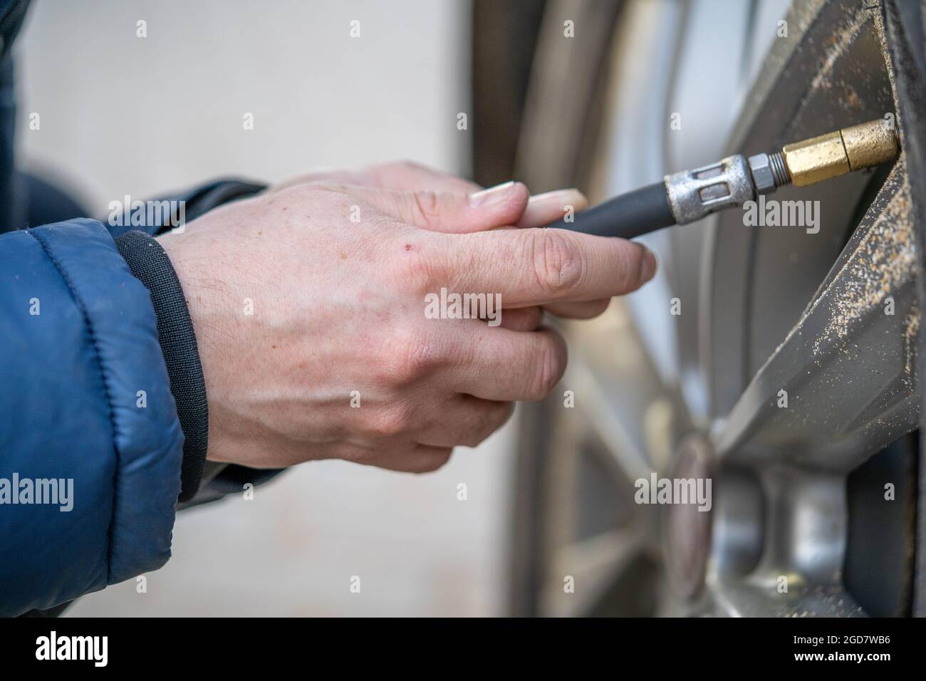 Closeup shot of a mechanic inflating tire Stock Photo - Alamy