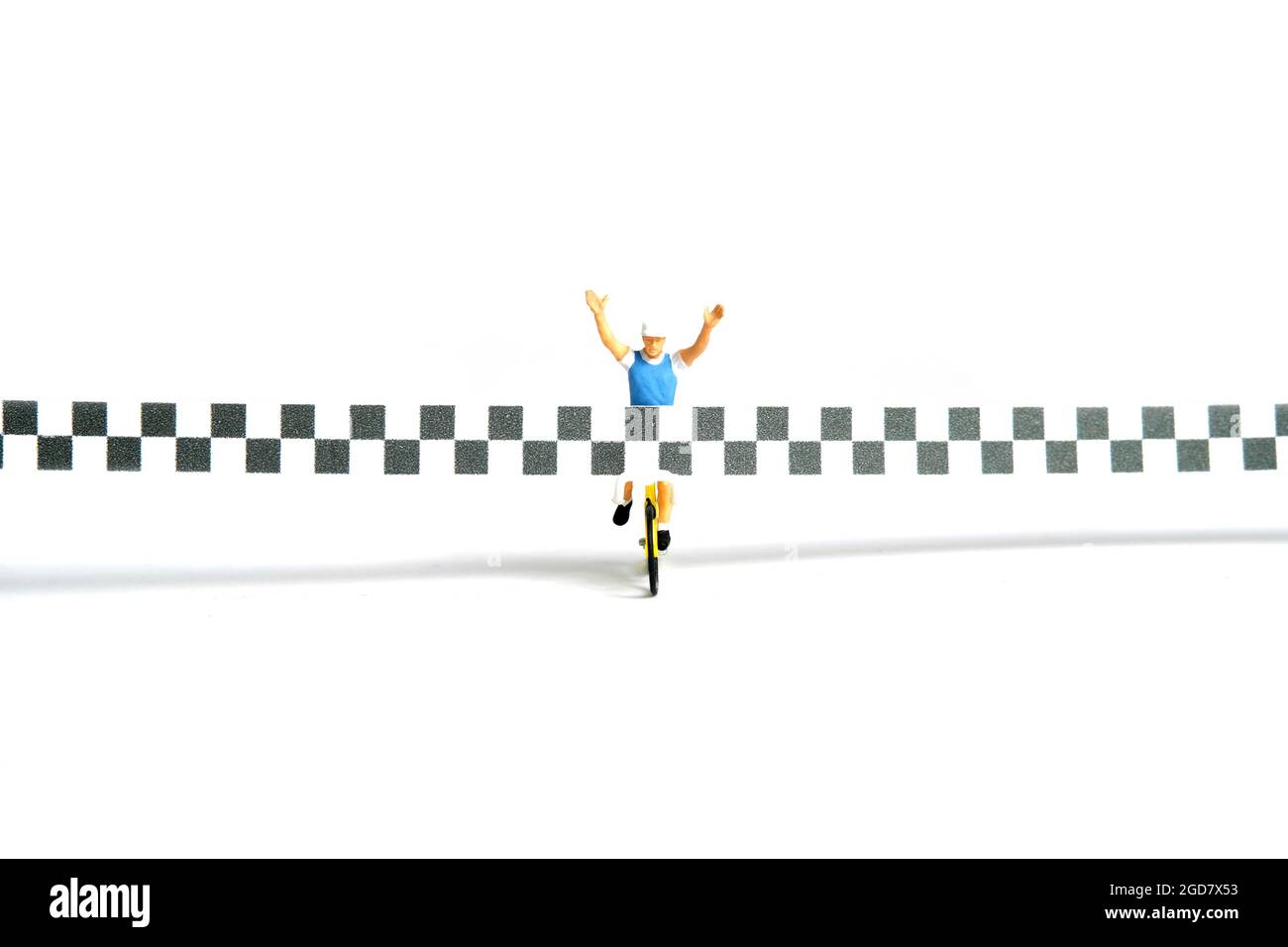 Miniature people toy figure photography. A biker with finish line ...