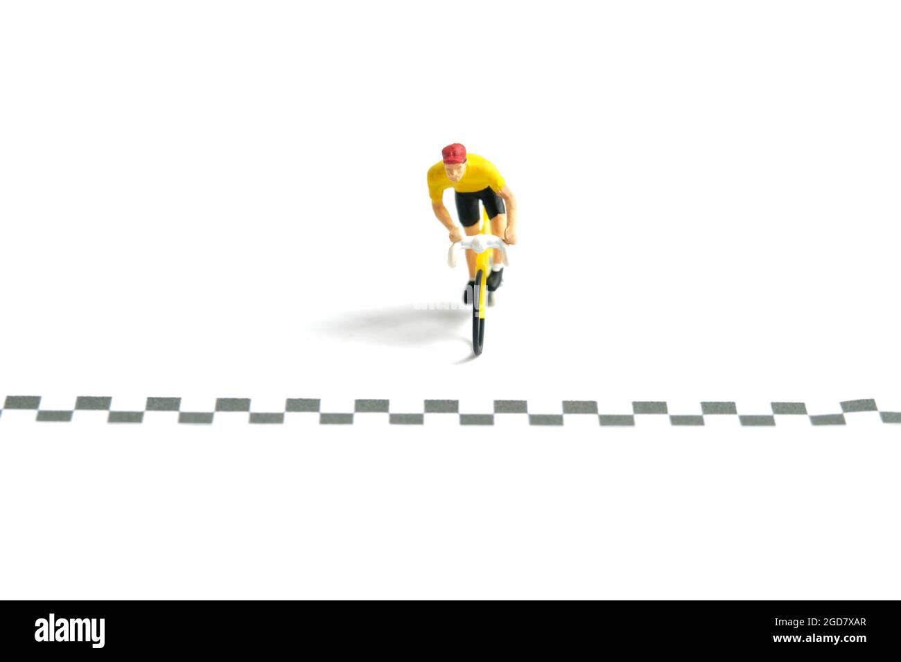 Miniature people toy figure photography. A biker with finish line ...