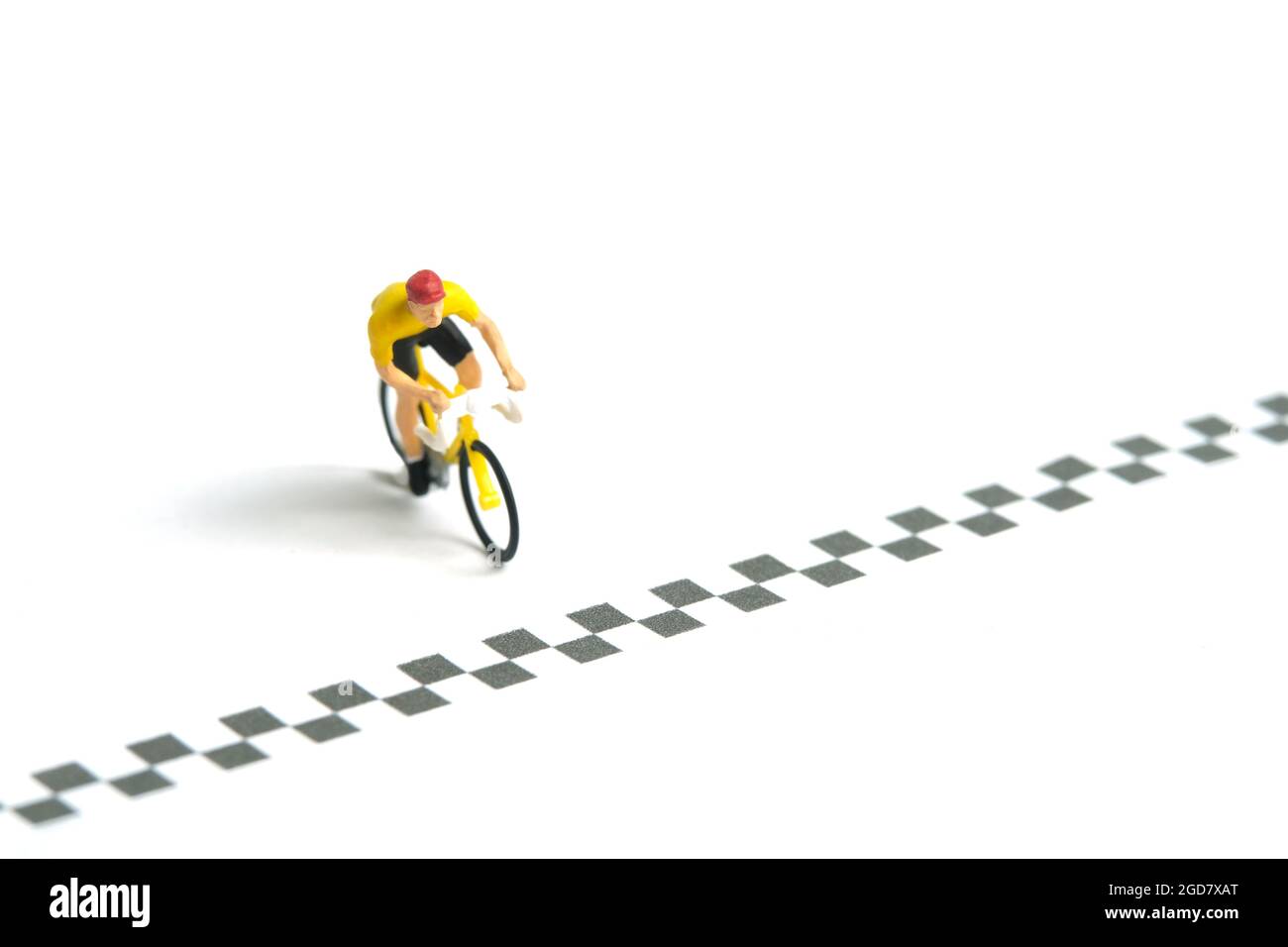 Miniature people toy figure photography. A biker with finish line ...