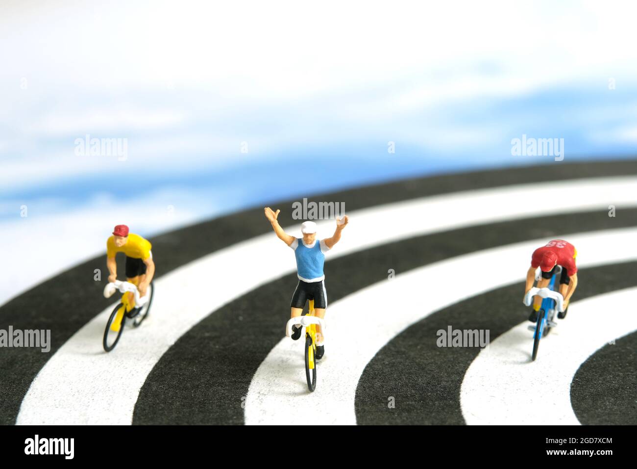 Miniature people toy figure photography. Bike cycling track. A biker ...