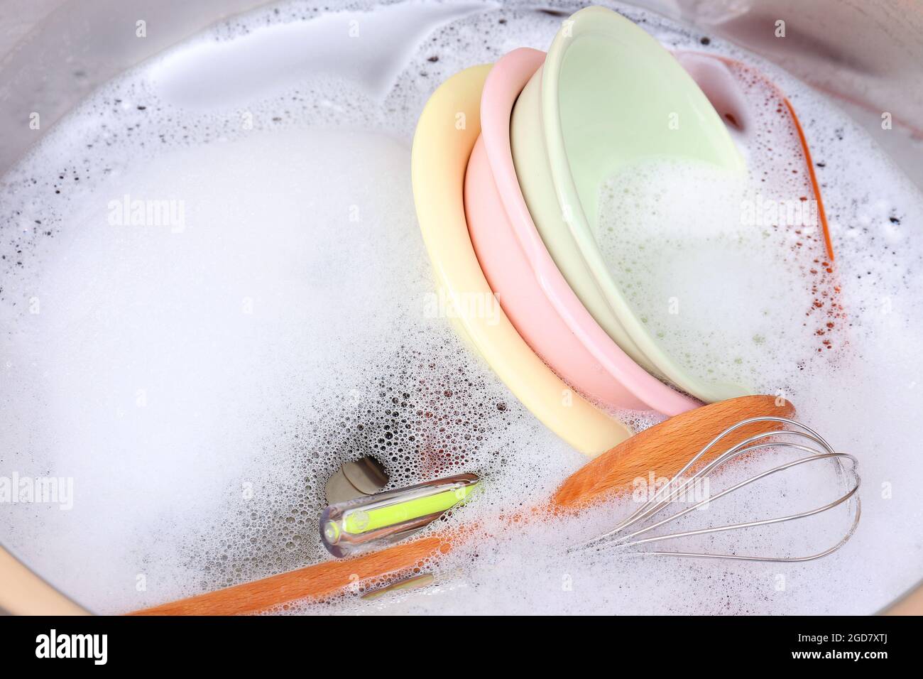 Utensils soaking in kitchen sink Stock Photo - Alamy